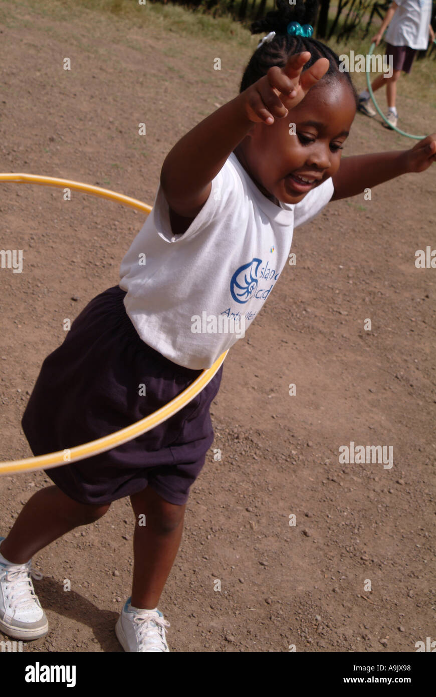Children playing outside with plastic hula hoops Stock Photo - Alamy
