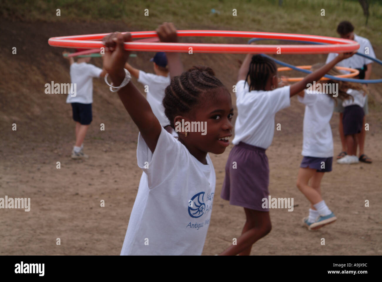 Children playing outside with plastic hula hoops Stock Photo - Alamy