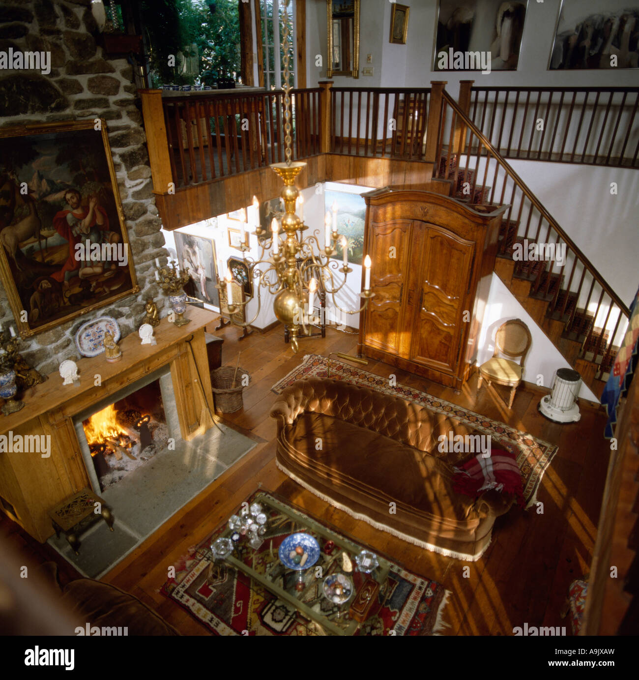 Aerial view from landing of sitting room with lighted fire in fireplace ...