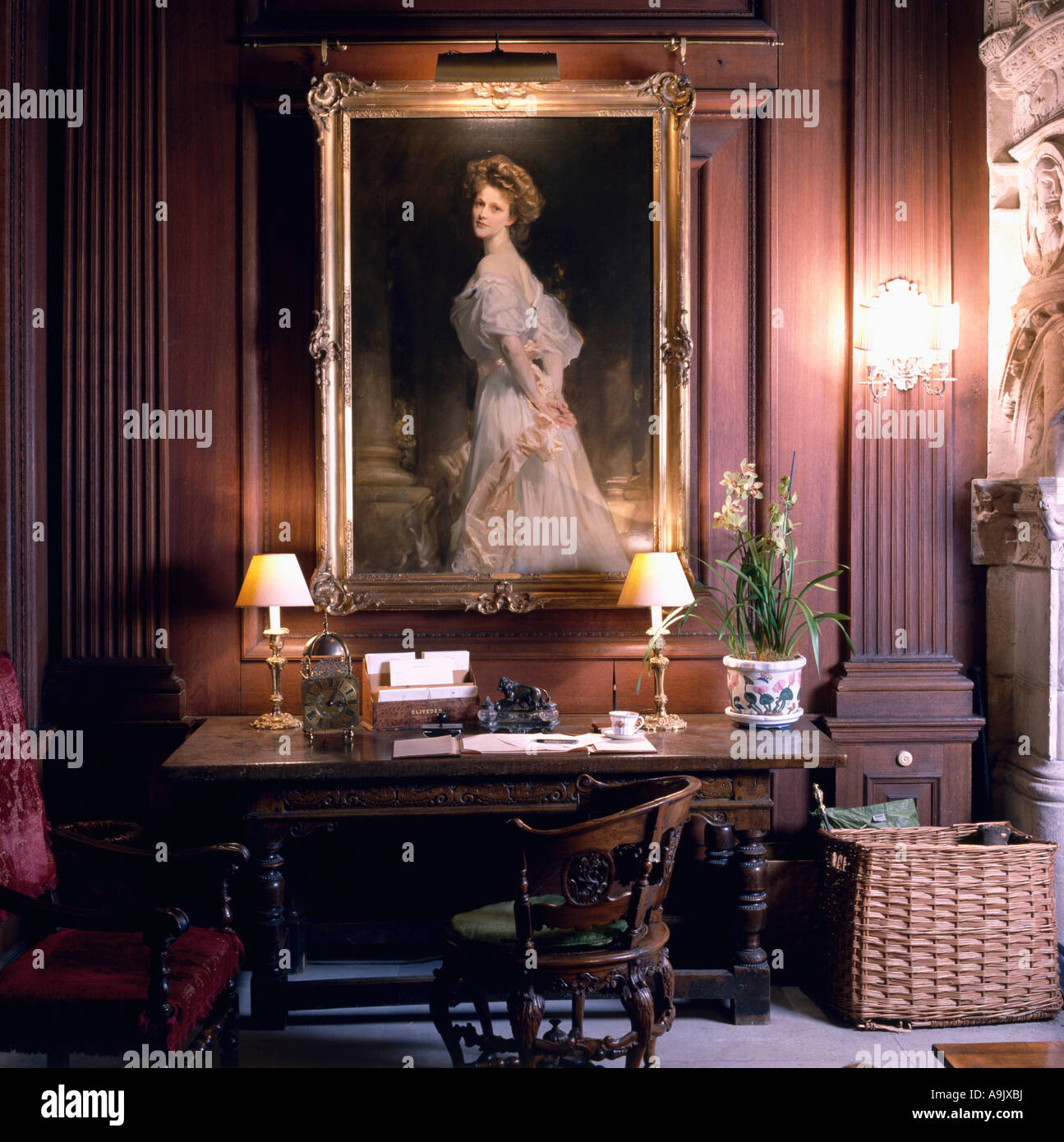 Large portrait painting over desk in panelled study Stock Photo - Alamy
