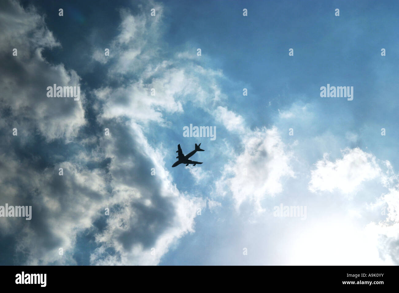 aeroplane flying into the clouds Stock Photo - Alamy