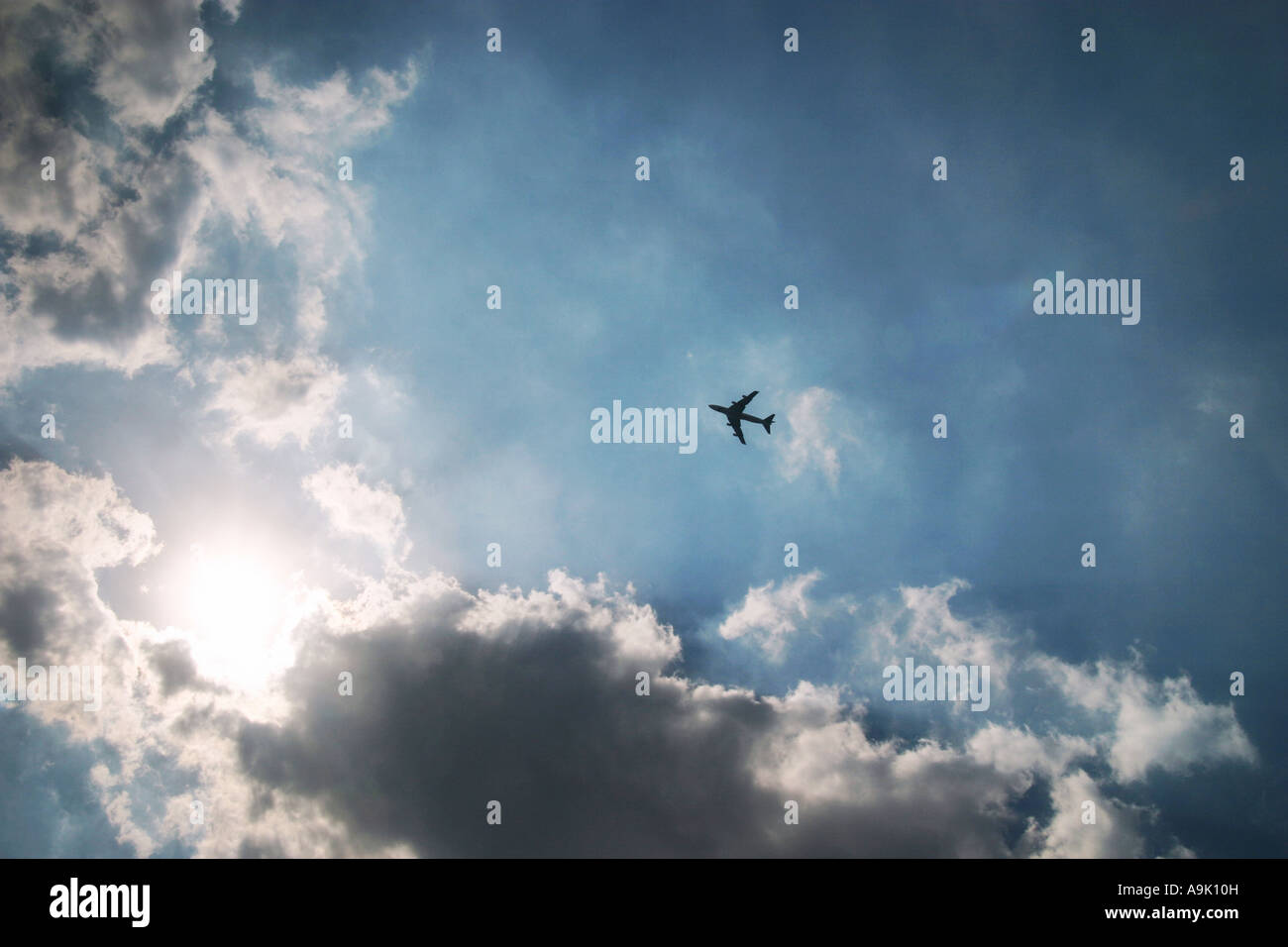 aeroplane flying into the clouds Stock Photo - Alamy