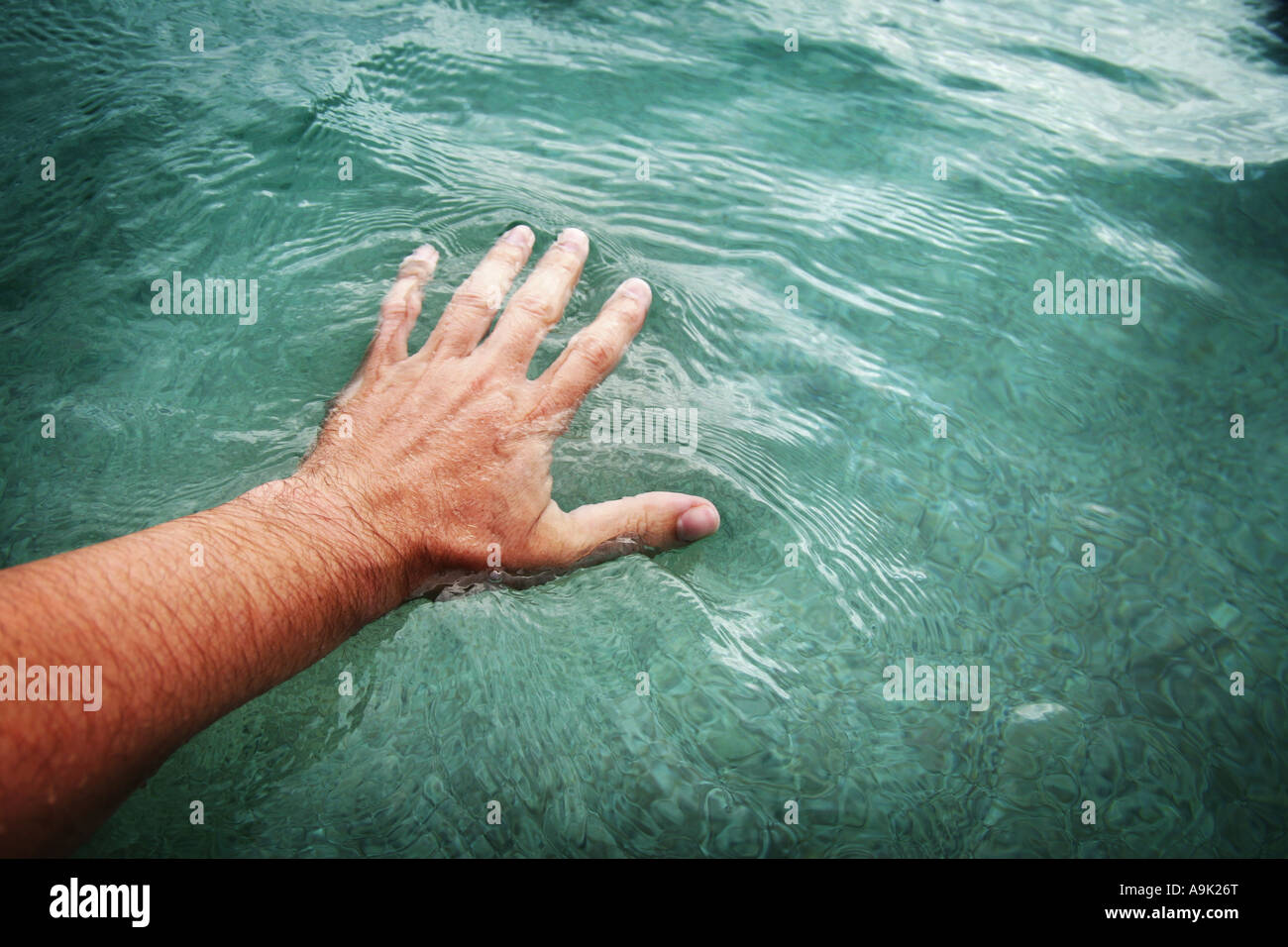 outstretched hand touching water Stock Photo - Alamy