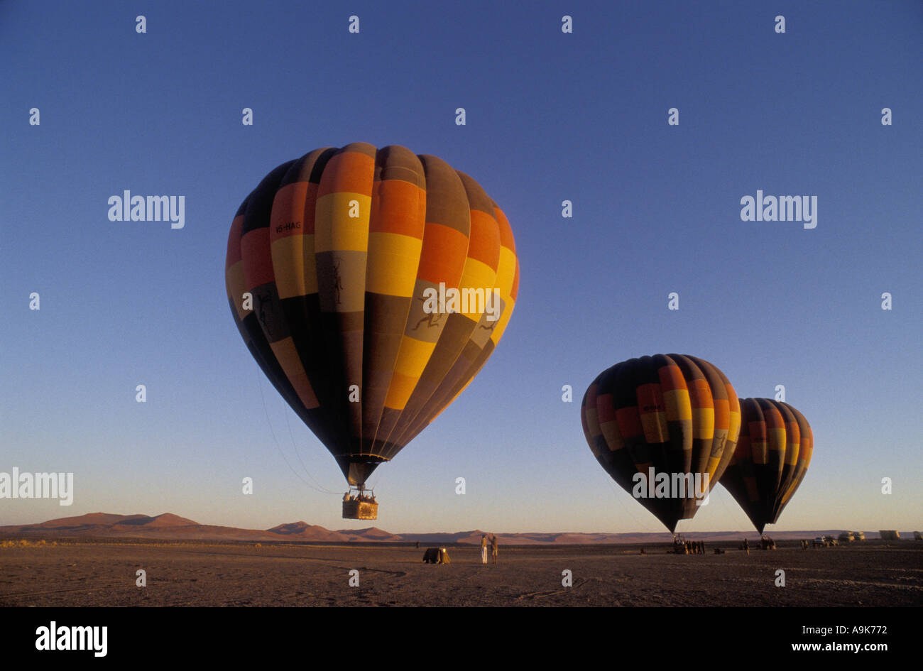 Three hot air balloons ready for take off at dawn in the Namib Naukluft ...