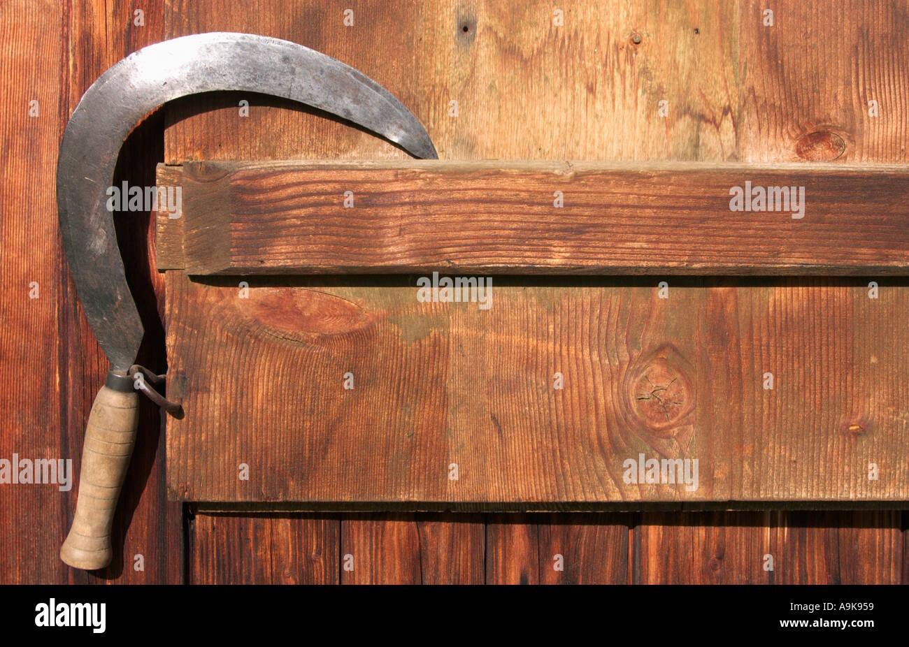 sickle on a wooden facade Stock Photo - Alamy