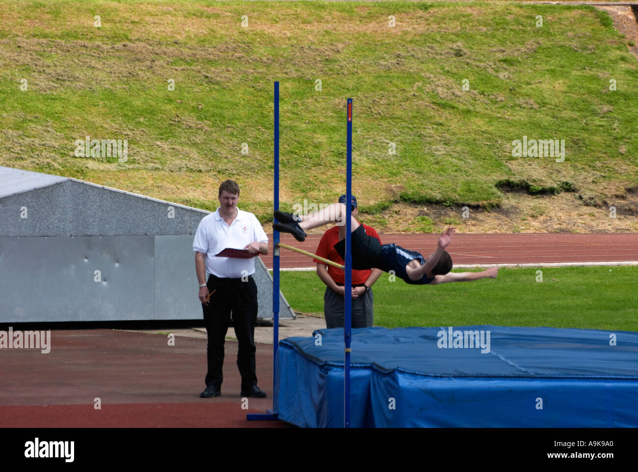 boy jumping over hi jump at an athletics competition Stock Photo - Alamy