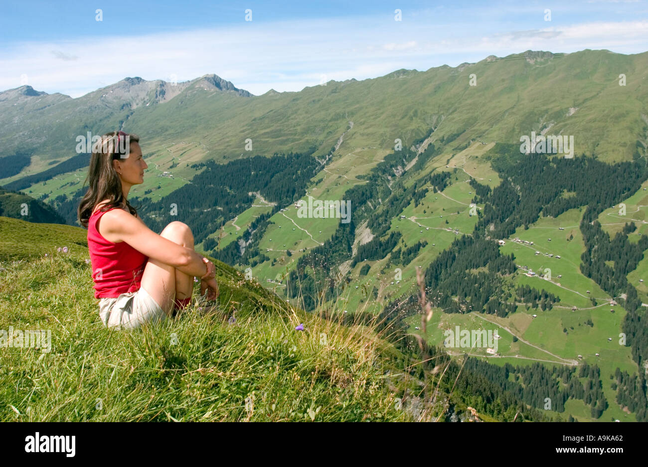 female wanderer making a pause in the mountains of swiss canton ...