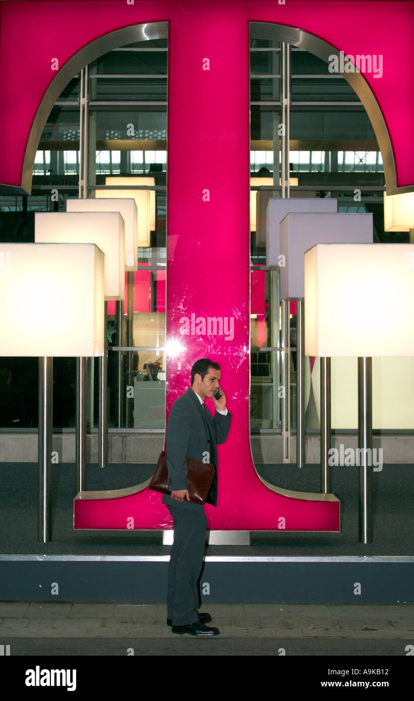 Visitor of the Computer Fair CeBIT 2004 in front of a Telekom Symbol ...