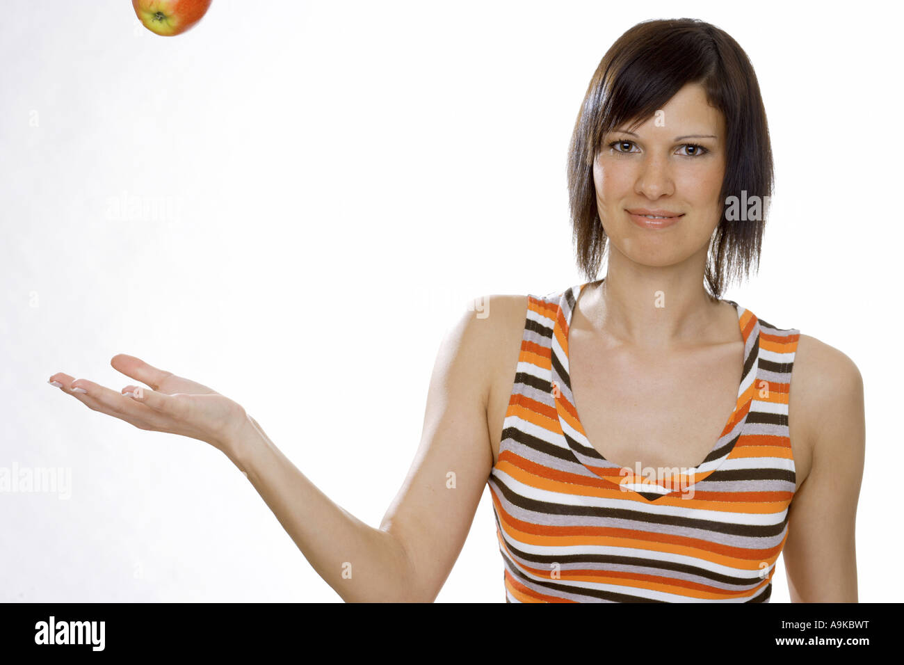 young woman throwing an apple Stock Photo - Alamy