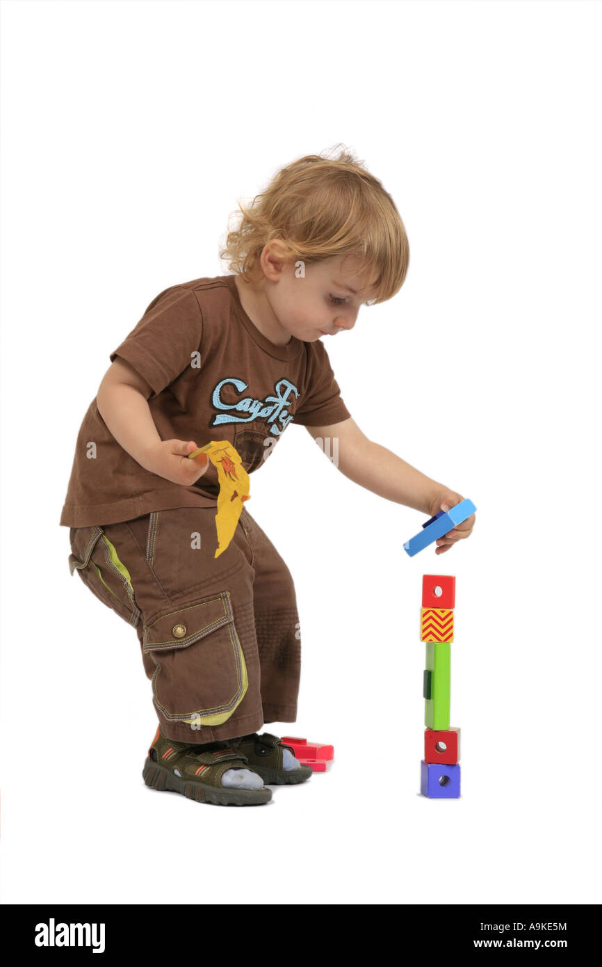 small boy builds brick tower, Germany Stock Photo - Alamy