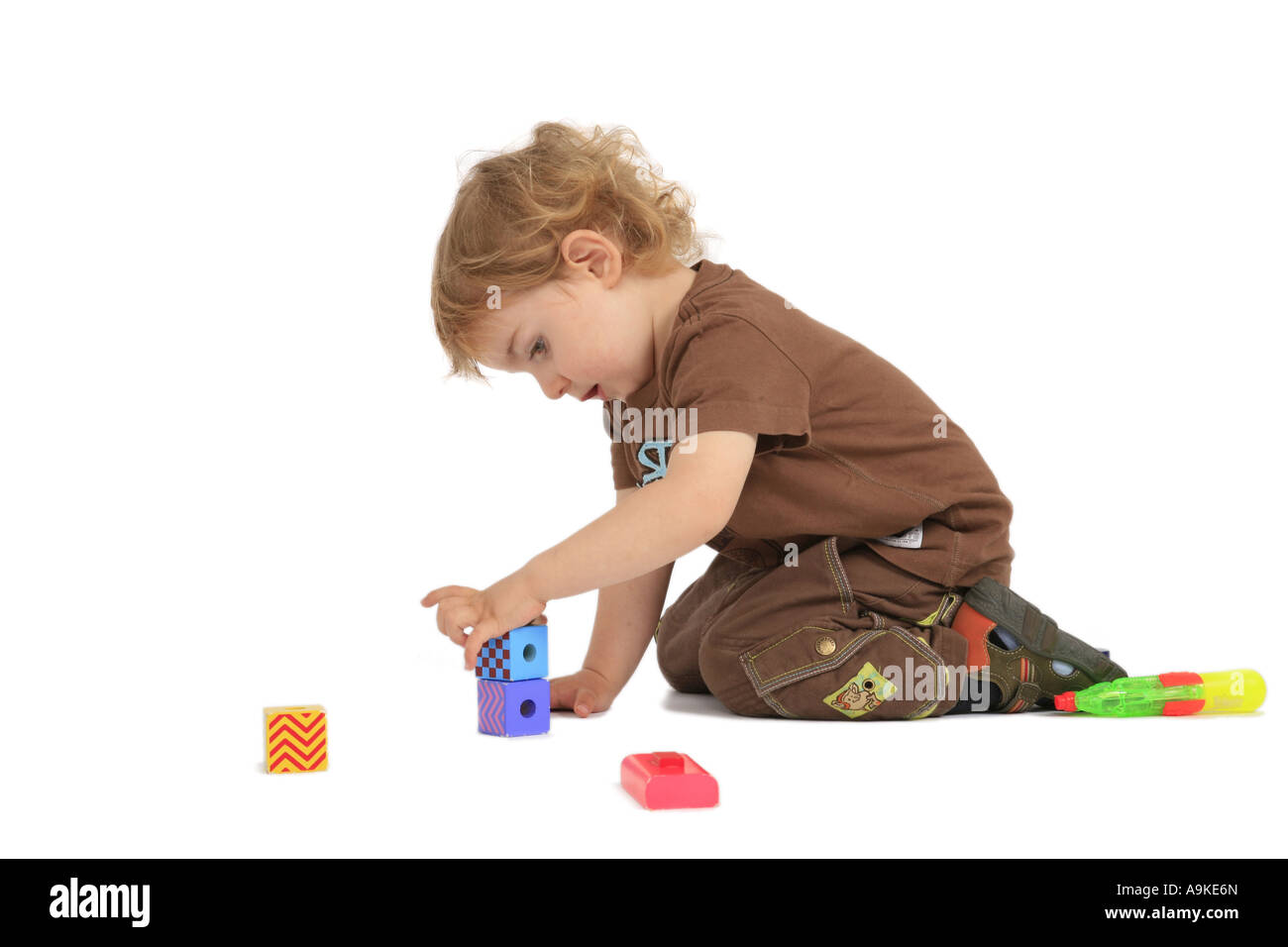 small boy builds brick tower, Germany Stock Photo - Alamy