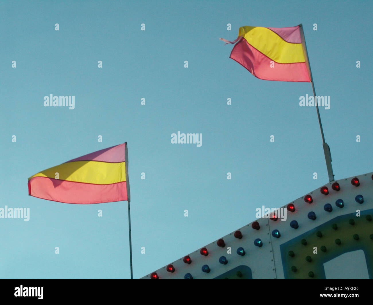 Two colorful flags blowing in a wind at the fair Stock Photo - Alamy