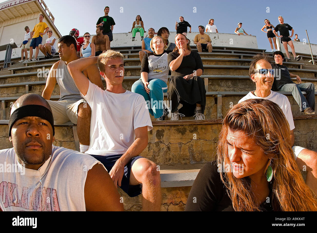 a group of strangers sit together on stadium seats in Santa Barbara ...
