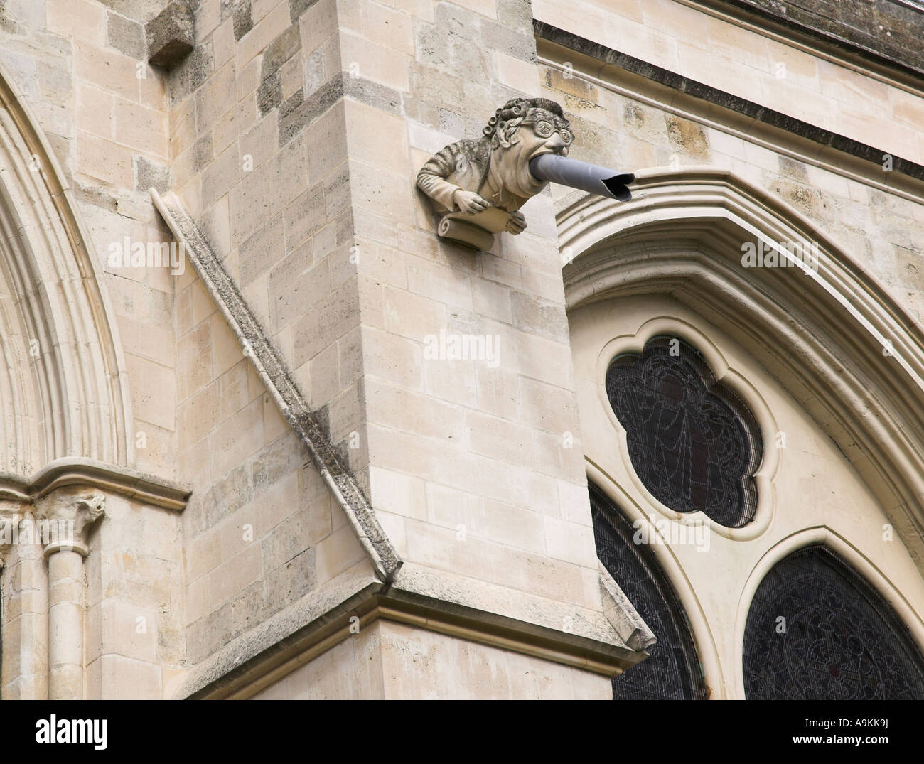 Modern restored replacement gargoyle modelled on a lawyer barrister or ...