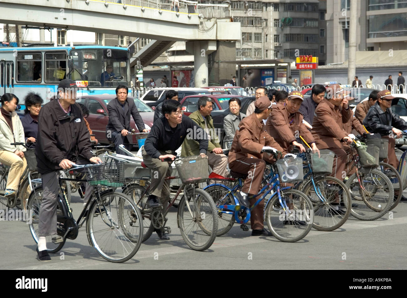 CYCLISTS WAIT AT TRAFFIC LIGHTS ON HEAVILY CONGESTED ROADS IN CENTRAL ...