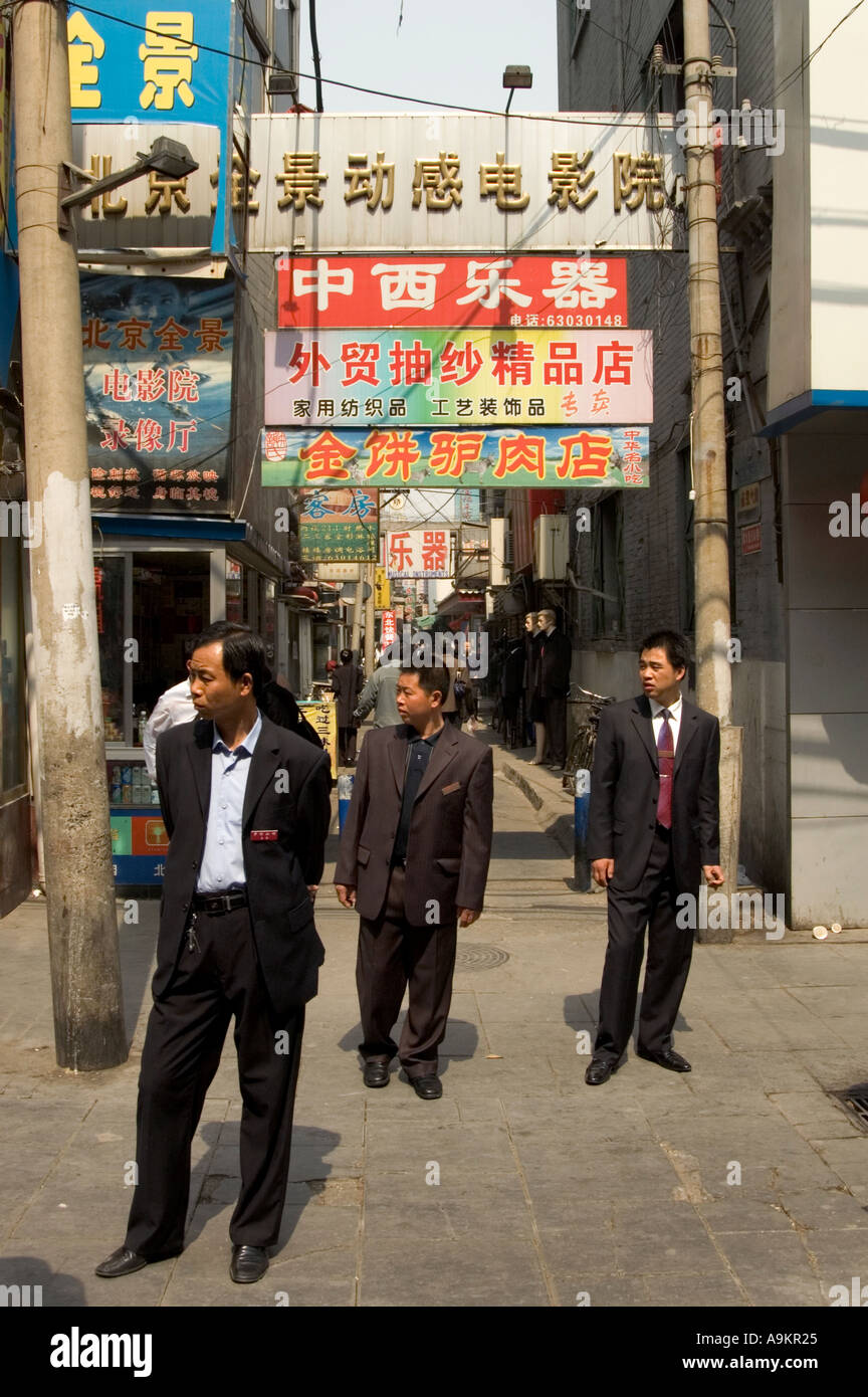 CHINESE SHOPKEEPERS ON THE LOOKOUT FOR CUSTOMERS IN A DOWNTOWN HUTONG ...
