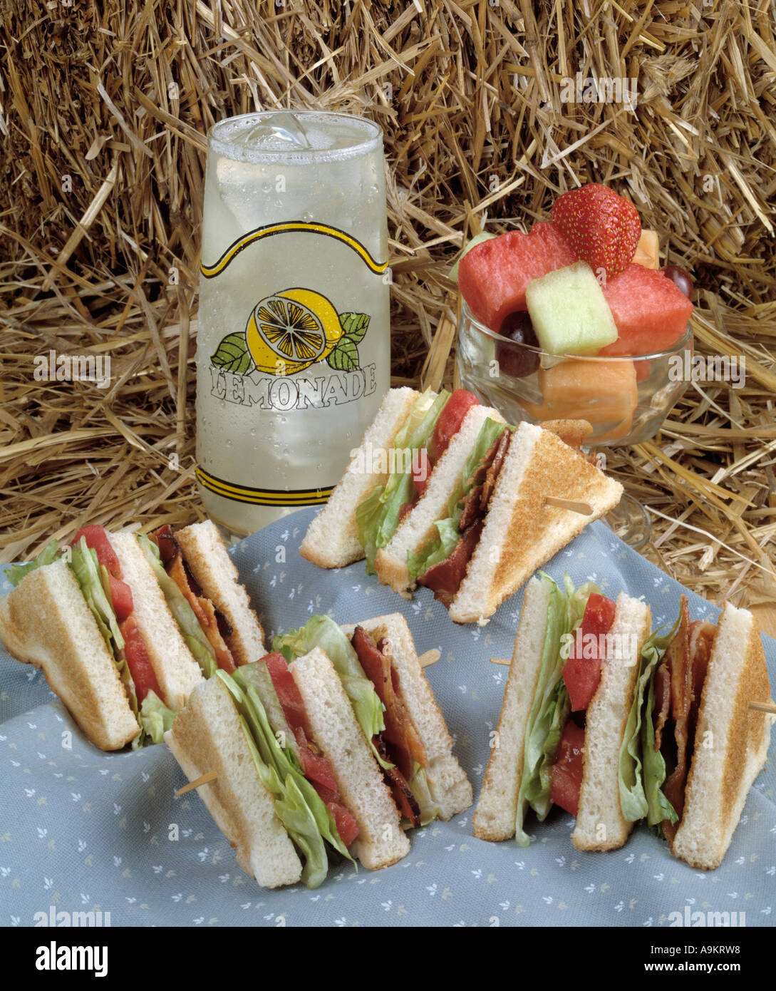 toasted club sandwich bacon lettuce tomato tomatoe fruit cup glass iced ...