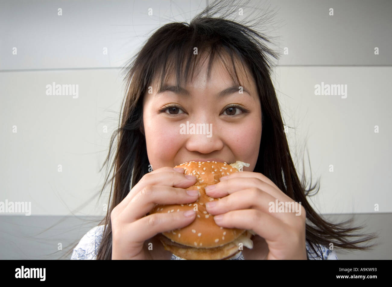 MODEL RELEASED YOUNG CHINESE WOMAN EATING HAMBURGER AT MCDONALD S ...