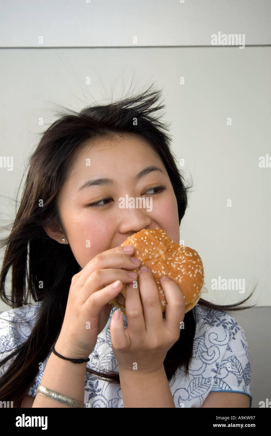 MODEL RELEASED YOUNG CHINESE WOMAN EATING HAMBURGER AT MCDONALD S ...