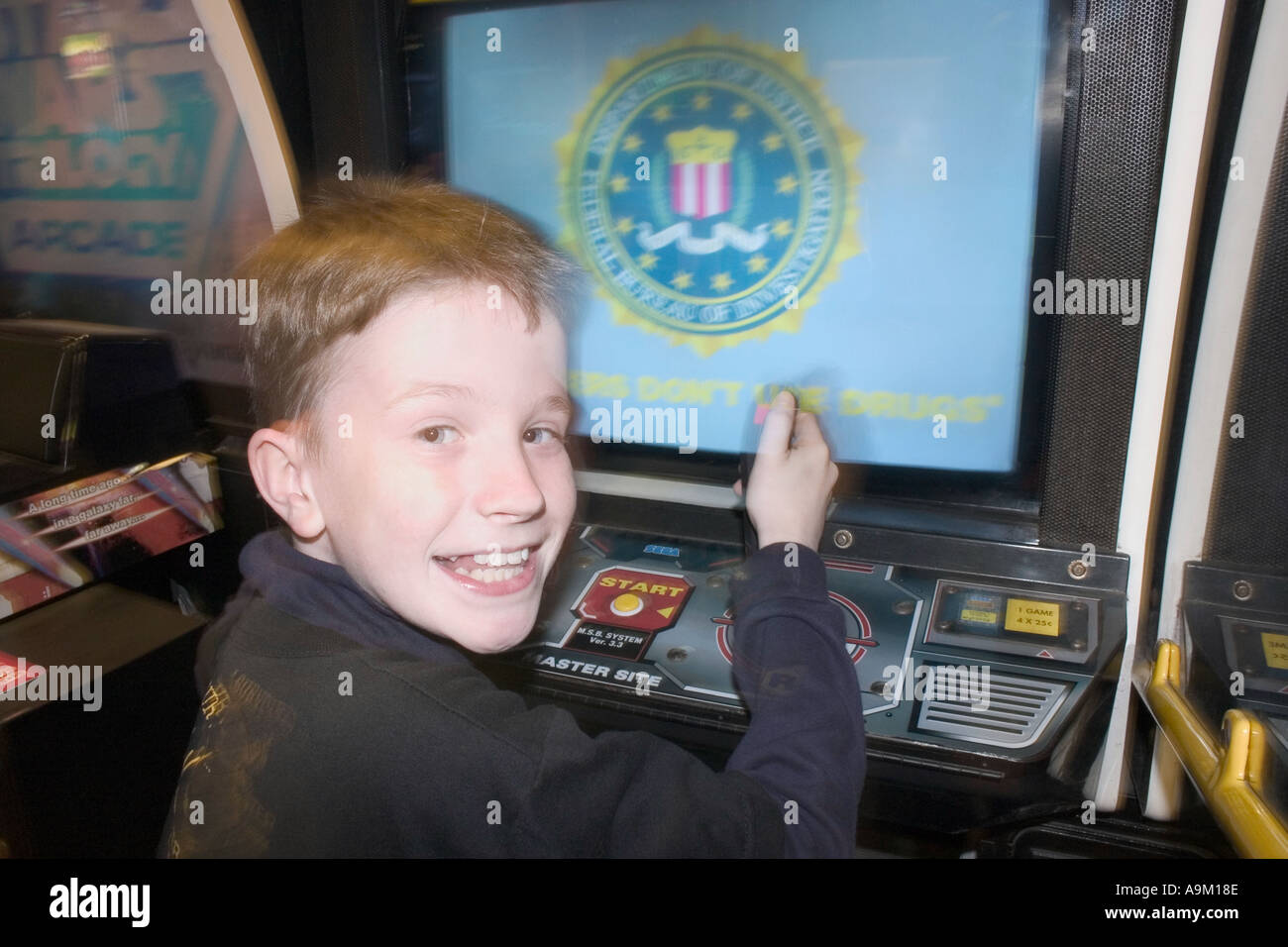 Teenager boy playing game in arcade hi-res stock photography and images ...