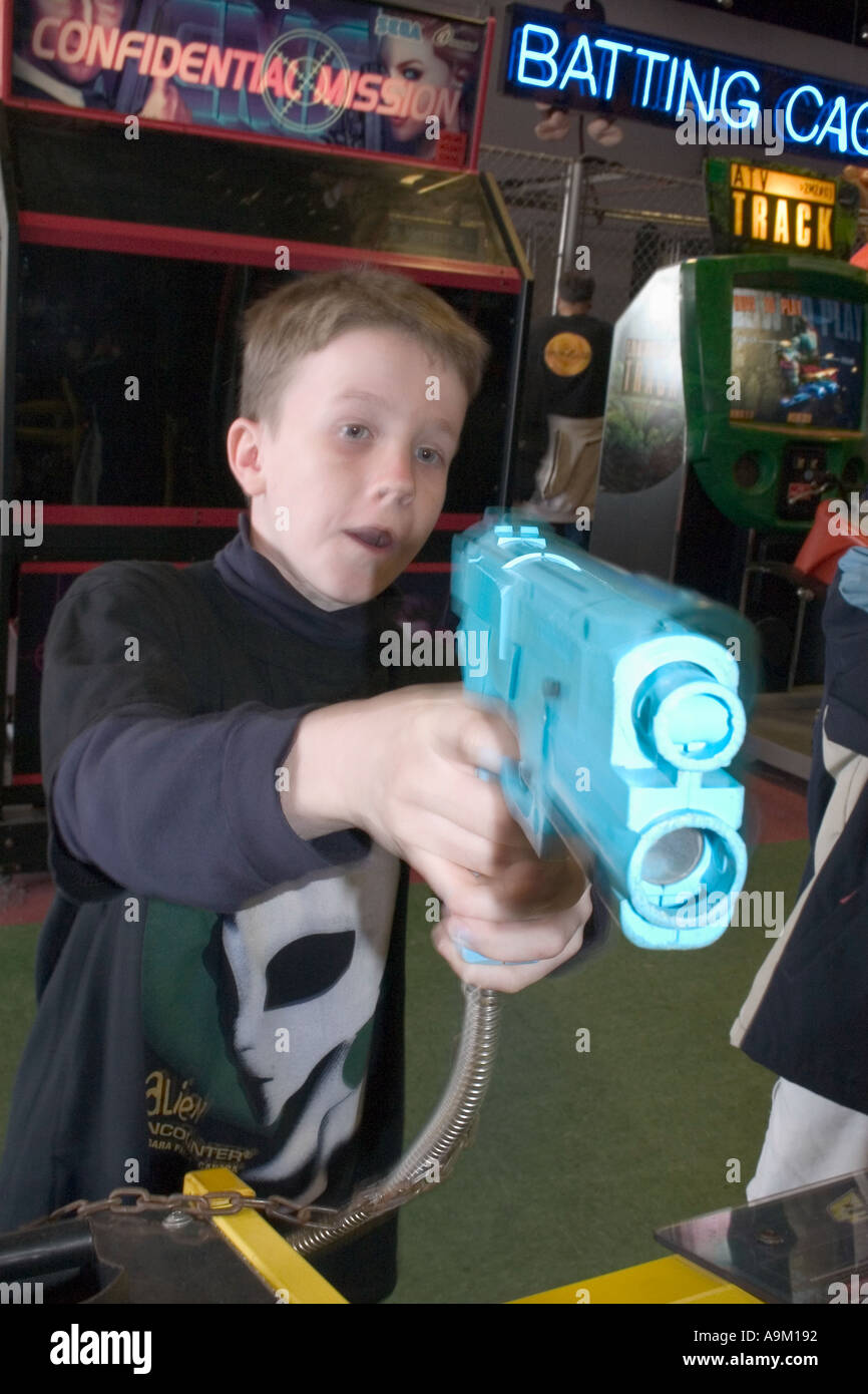 Boy playing video game in arcade Stock Photo - Alamy