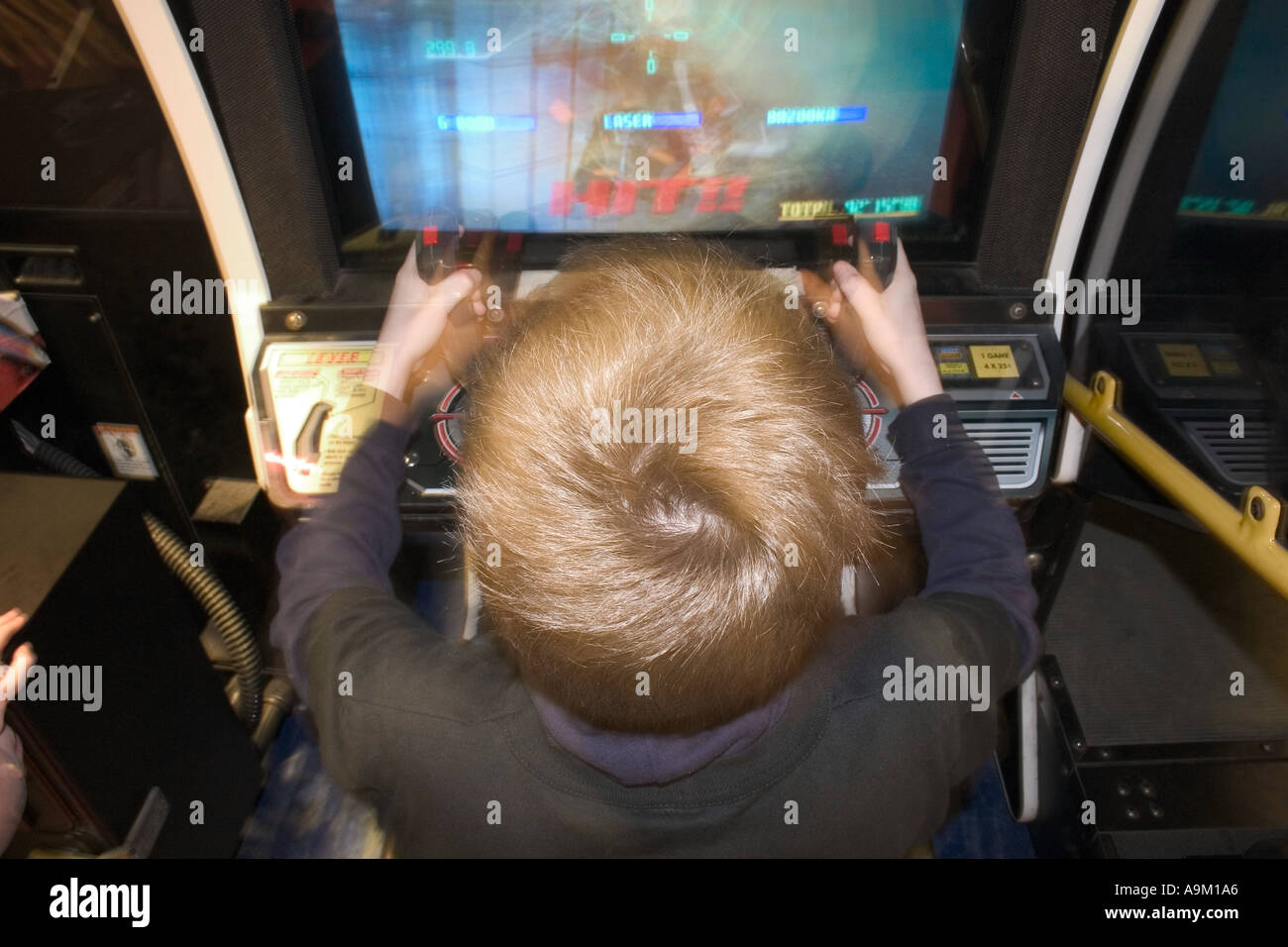 Teenager boy playing game in arcade hi-res stock photography and images ...