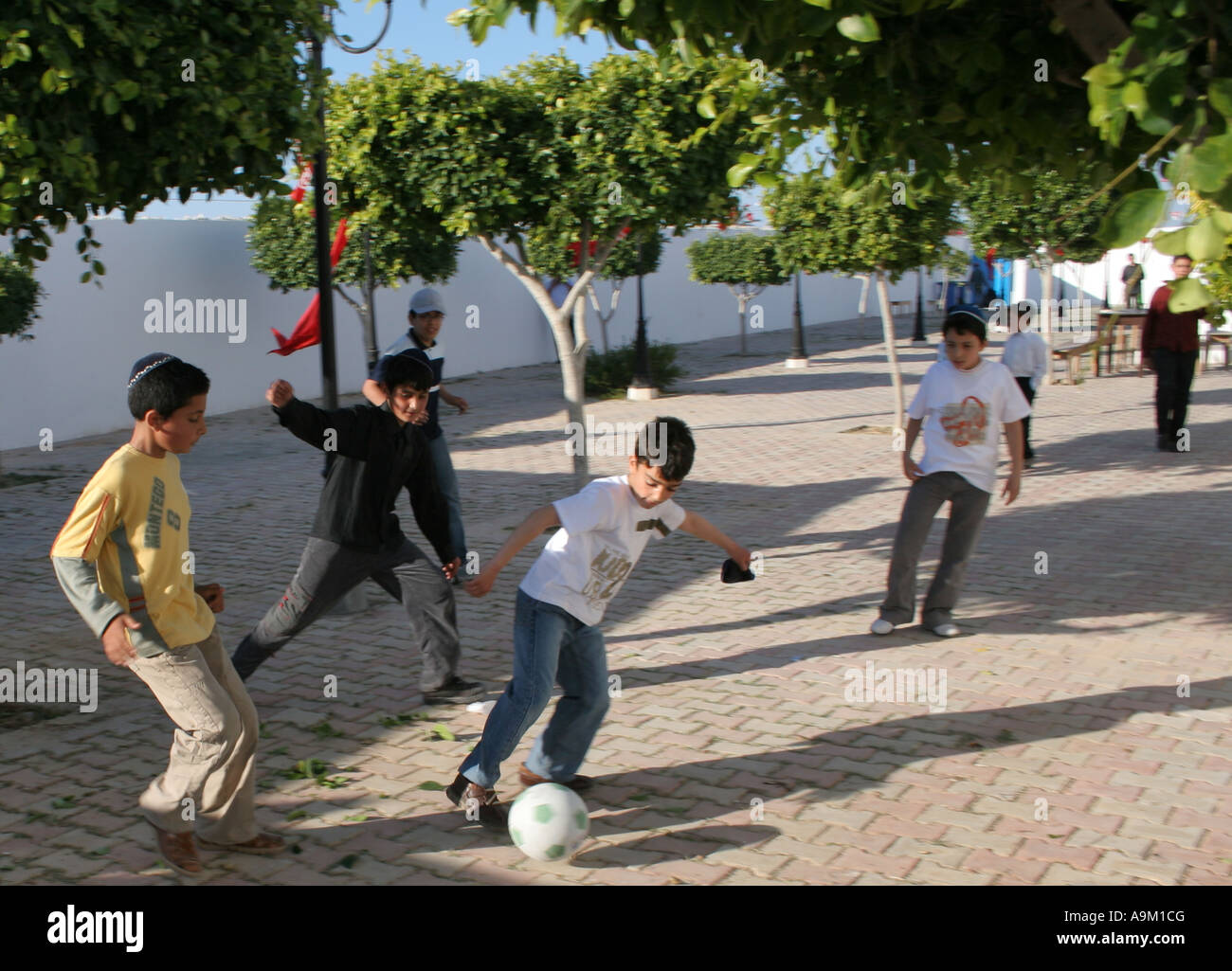 Jewish children playing football at the La Griba synagogue Djerba Stock ...