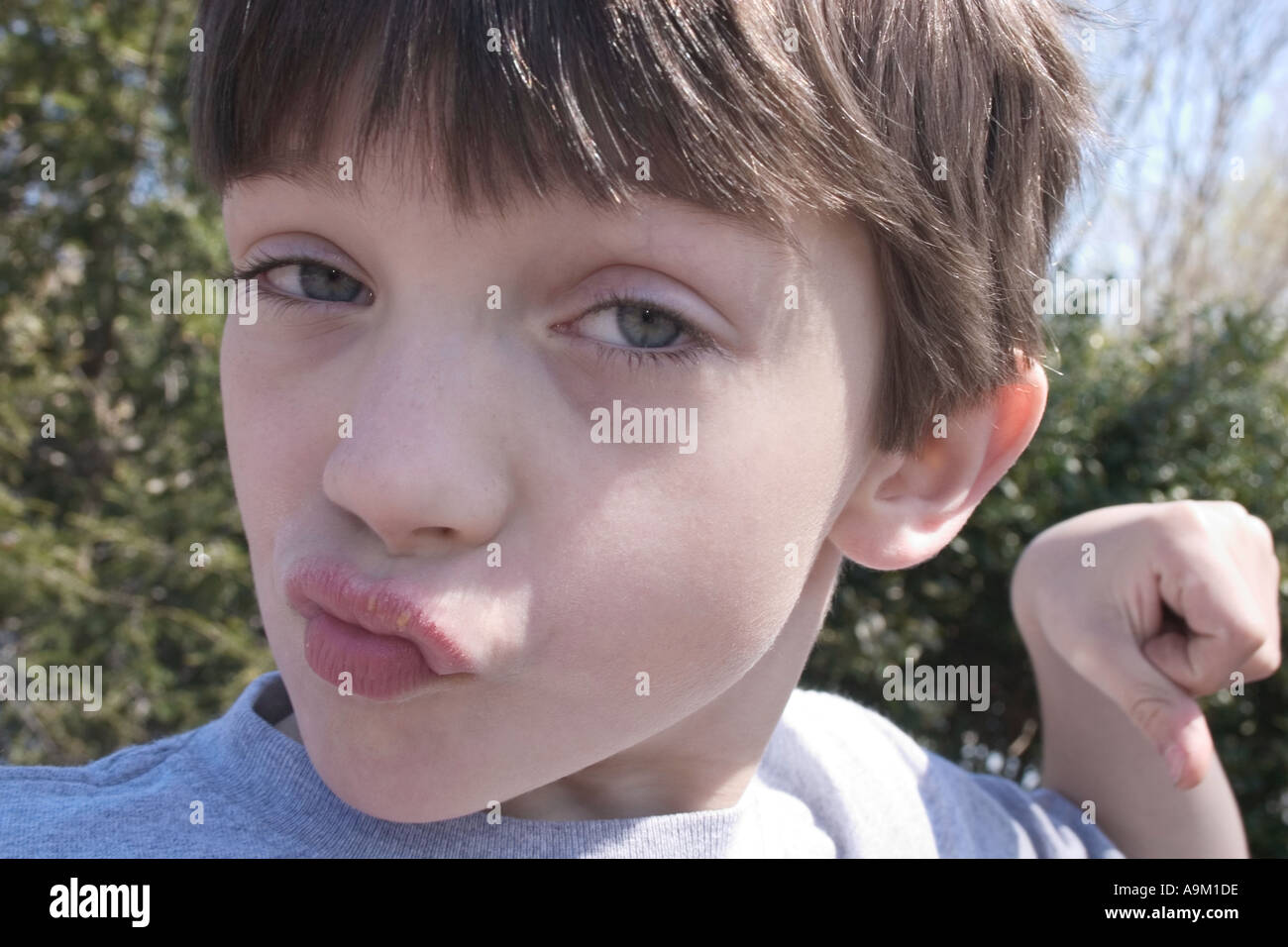 Boy age 8 making funny face Stock Photo - Alamy