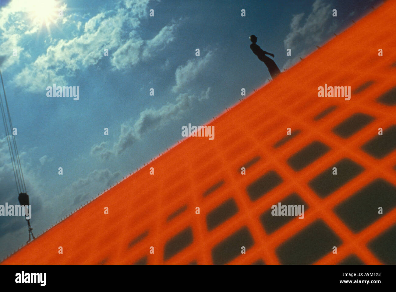 steel worker walking across building girders abstract Stock Photo - Alamy