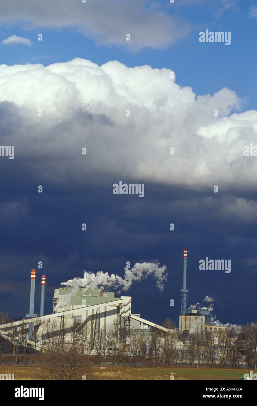large factory billowing smoke stack smokestacks against blue sky cloud ...