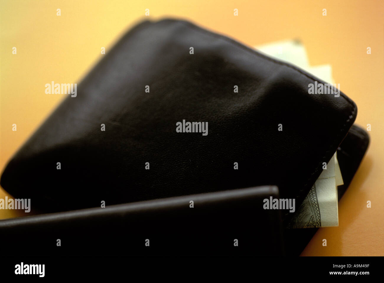 Black wallet with cash Stock Photo - Alamy