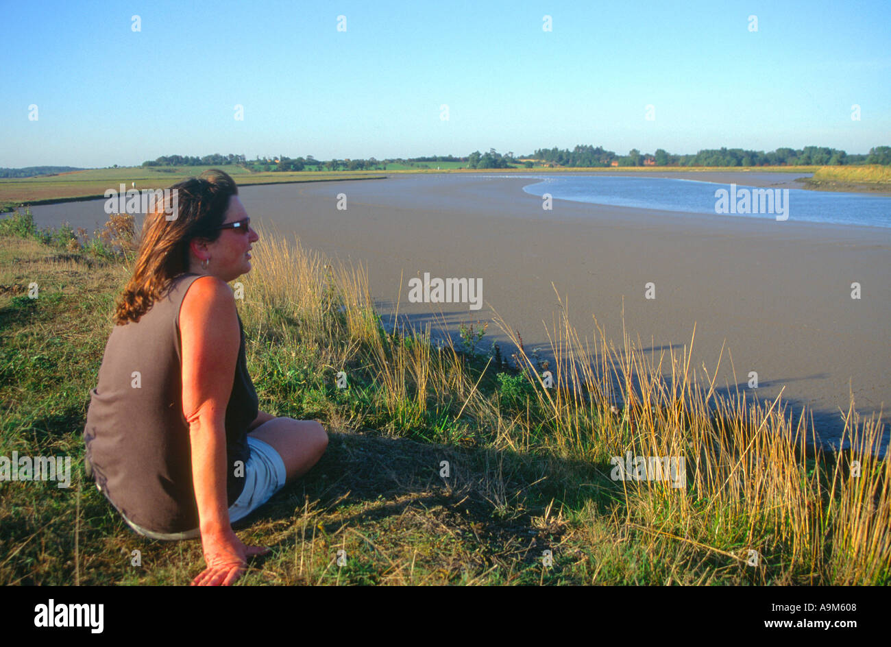 Woman enjoying sunshine Butley river creek Suffolk England Stock Photo ...
