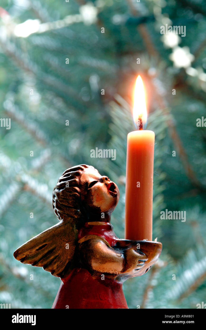 angel figure with burning candle Stock Photo - Alamy