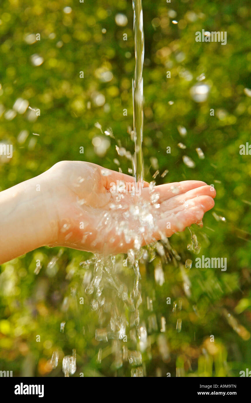 Water dropping into hand Stock Photo - Alamy