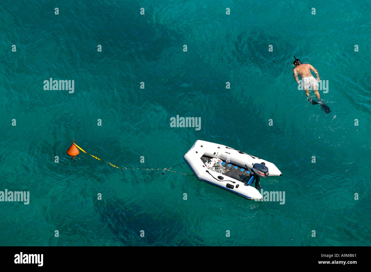 inflatable raft and diver in Cala Galdana Stock Photo - Alamy