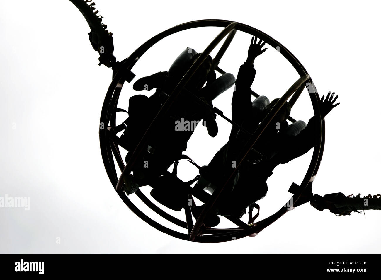 Silhouette of two people on a fairground ride Stock Photo - Alamy