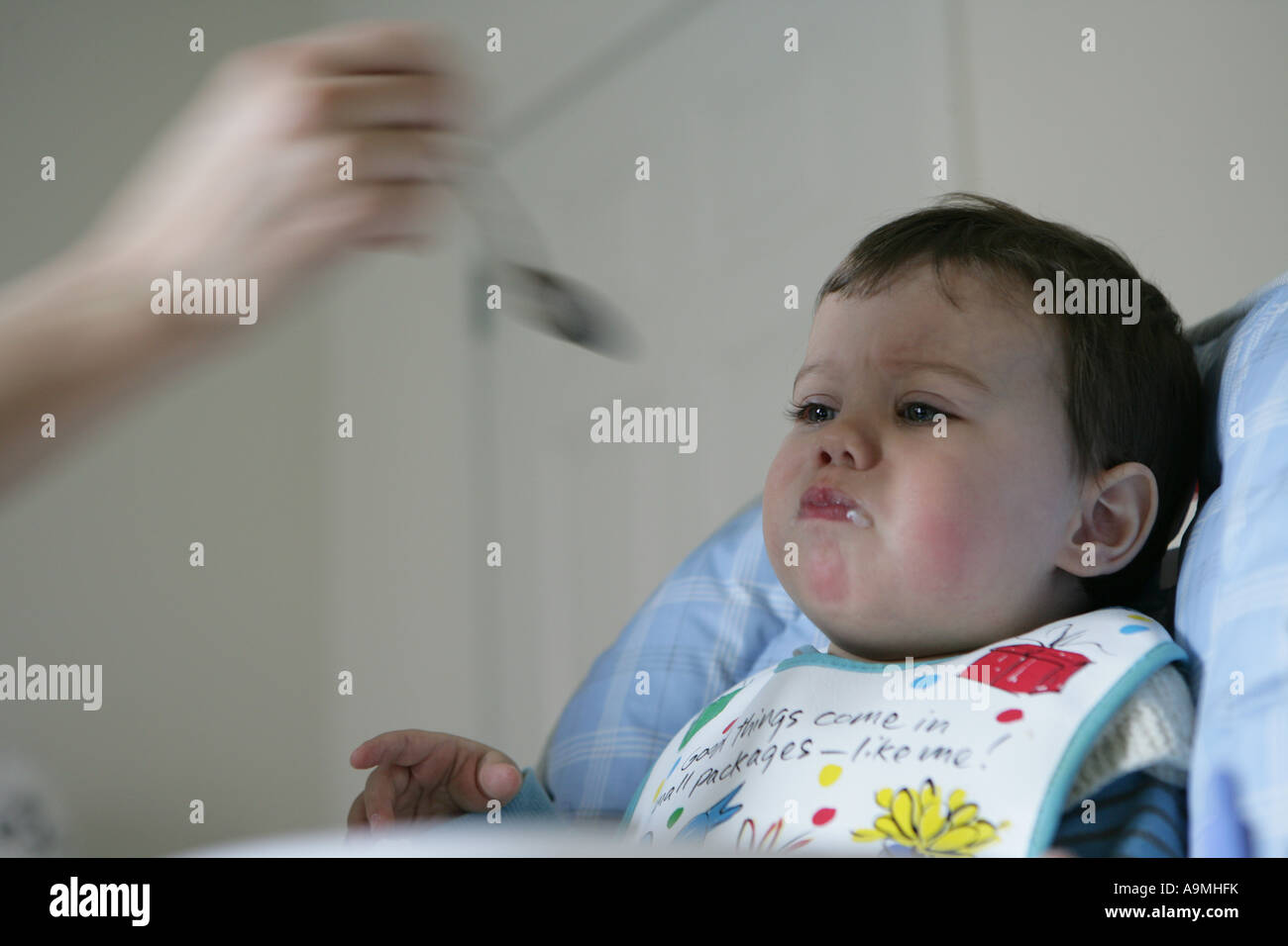 A child being fed from a spoon Stock Photo - Alamy