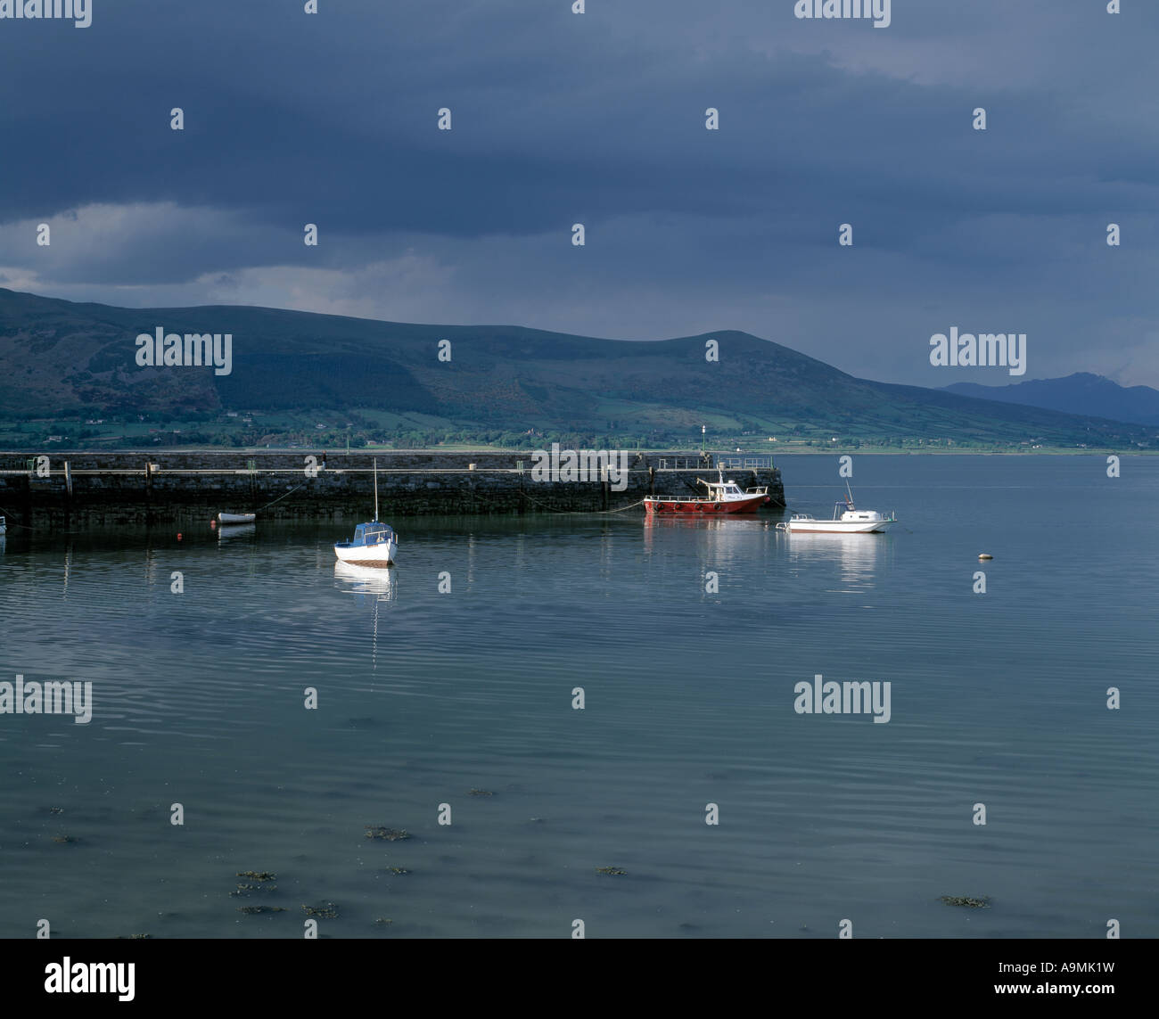 calm sea inlet on irelands east coast surrounded by mountains Stock ...