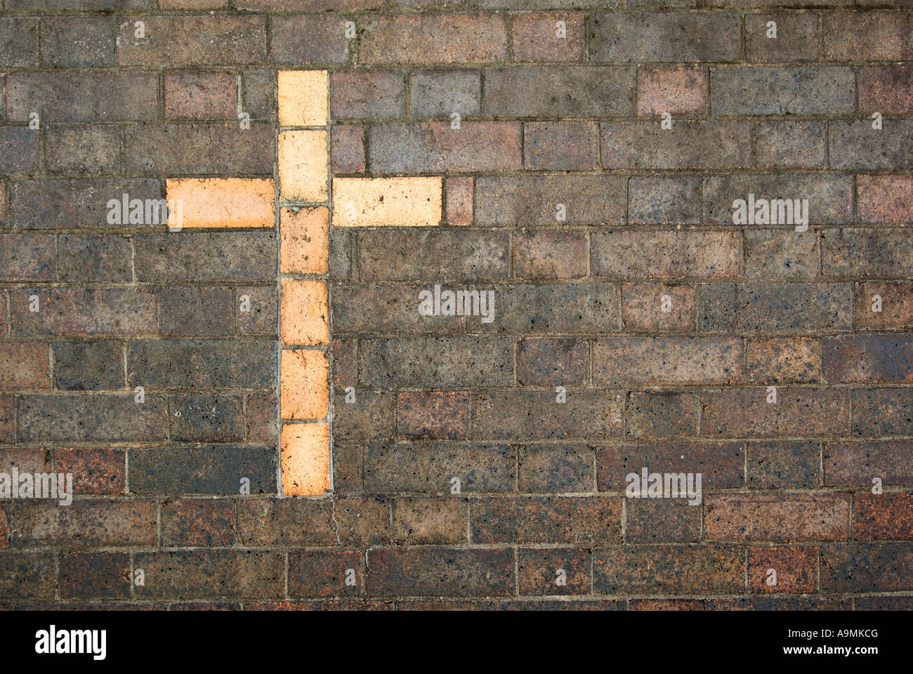 the cross of christ built into a brick wall as background Stock Photo ...