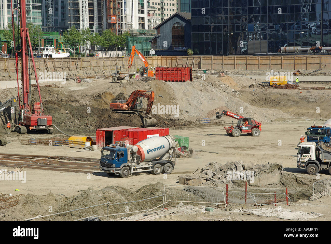 London Docklands busy construction site machines working on foundations ...