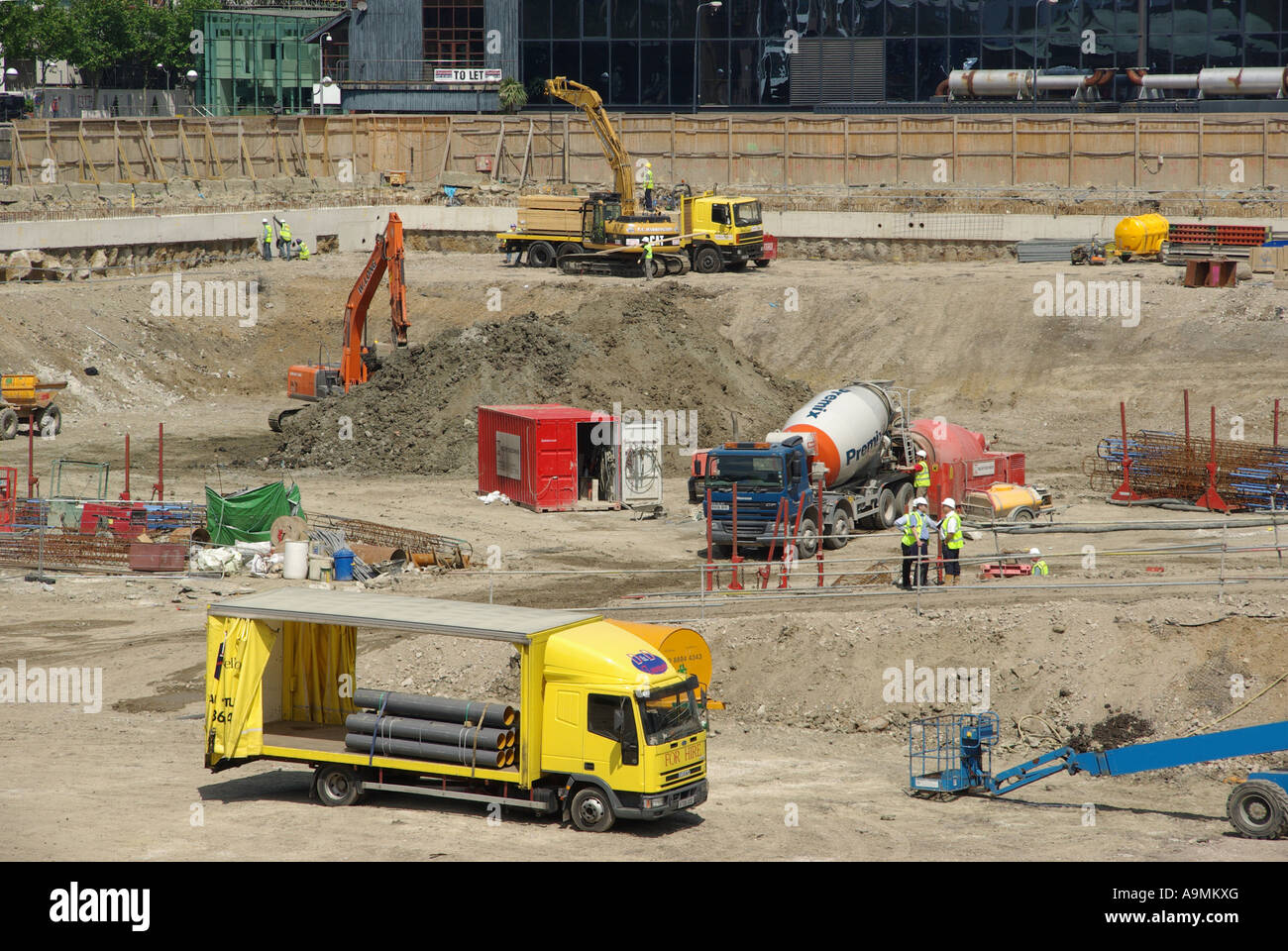 Busy construction building site machines & lorry truck materials ...