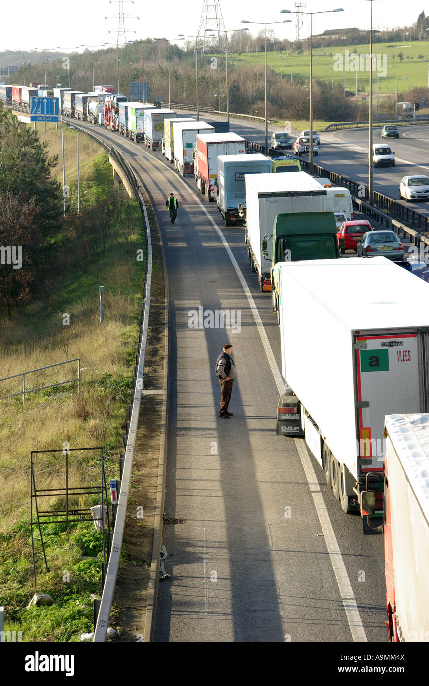 M25 motorway long stationary queue of articulated lorries with bored ...