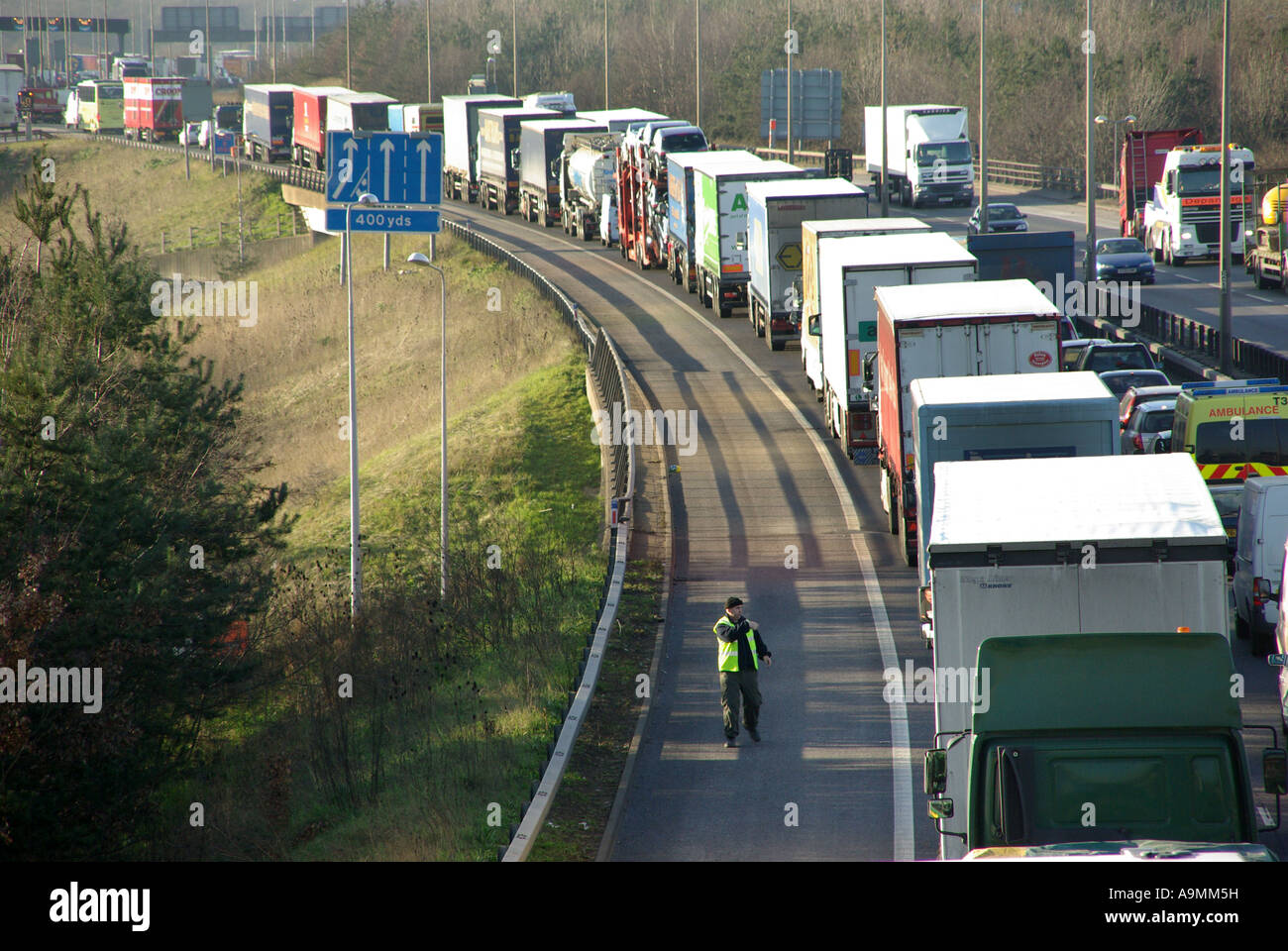 M25 motorway long stationary queue of articulated lorries with bored ...