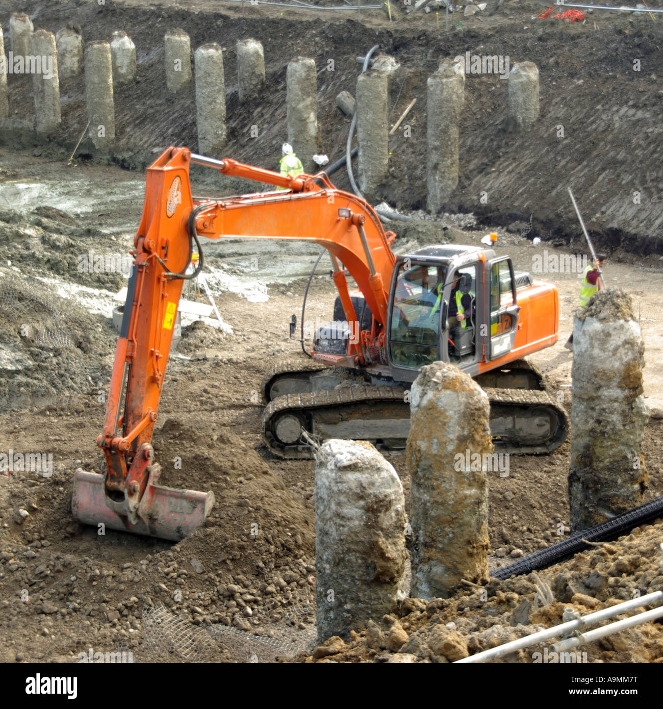 Looking down on building construction site mechanical excavator digger ...