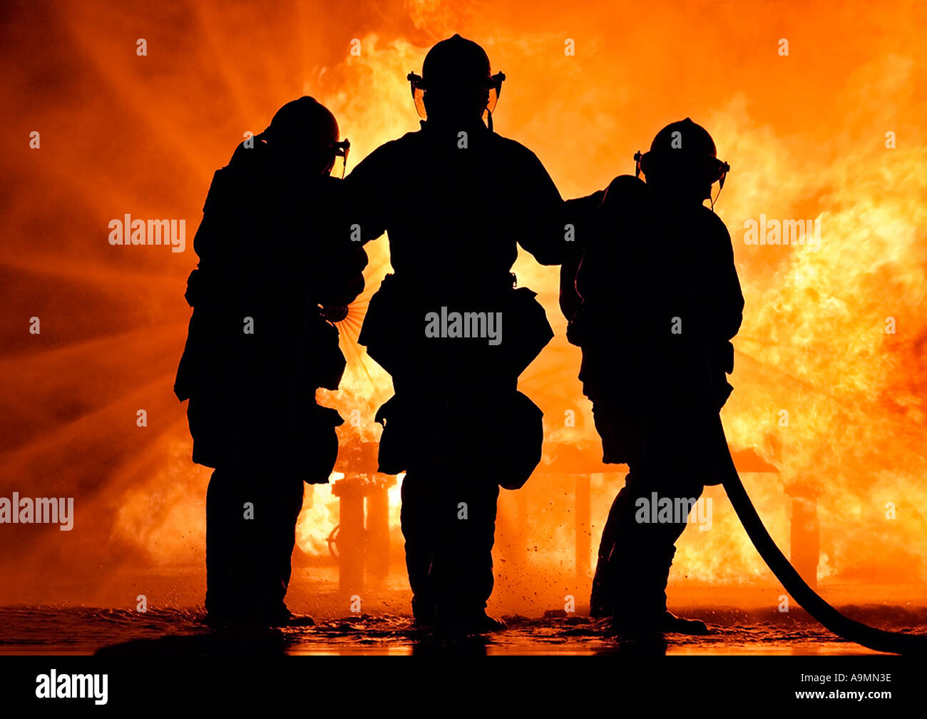 Firefighters showing teamwork Stock Photo - Alamy