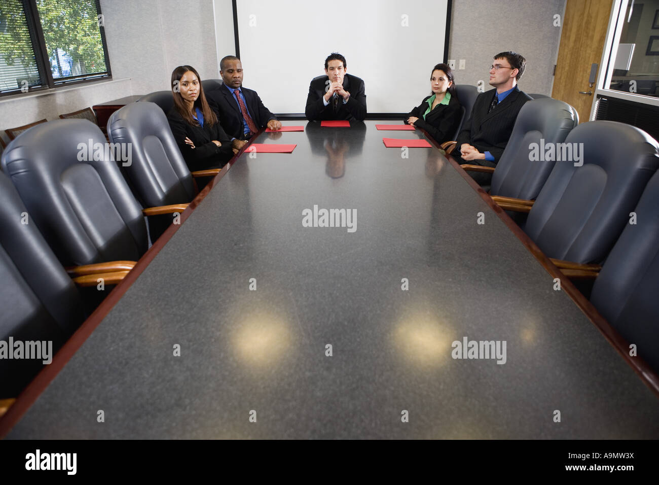 Business executives sitting together in a formal conference room Stock ...