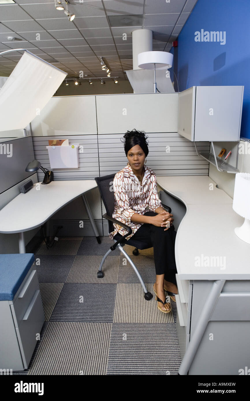 Portrait of a pensive young woman sitting in a new office cubicle Stock ...