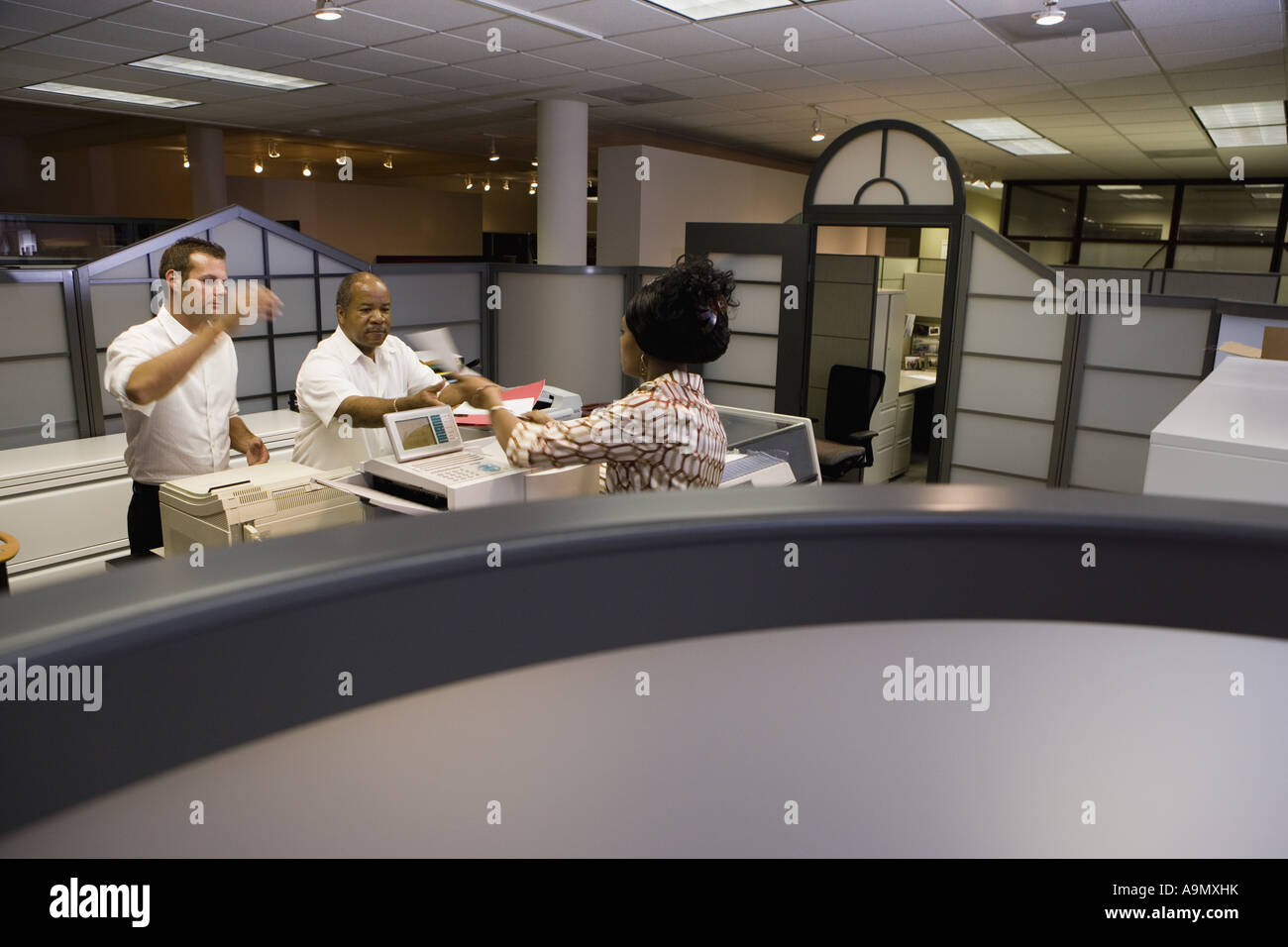 View of office worker at copy machine over cubicle wall Stock Photo - Alamy