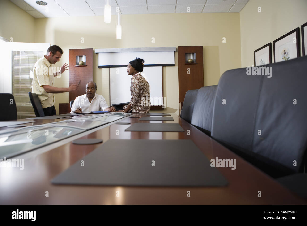 Business man and woman making a point to their colleague in a ...