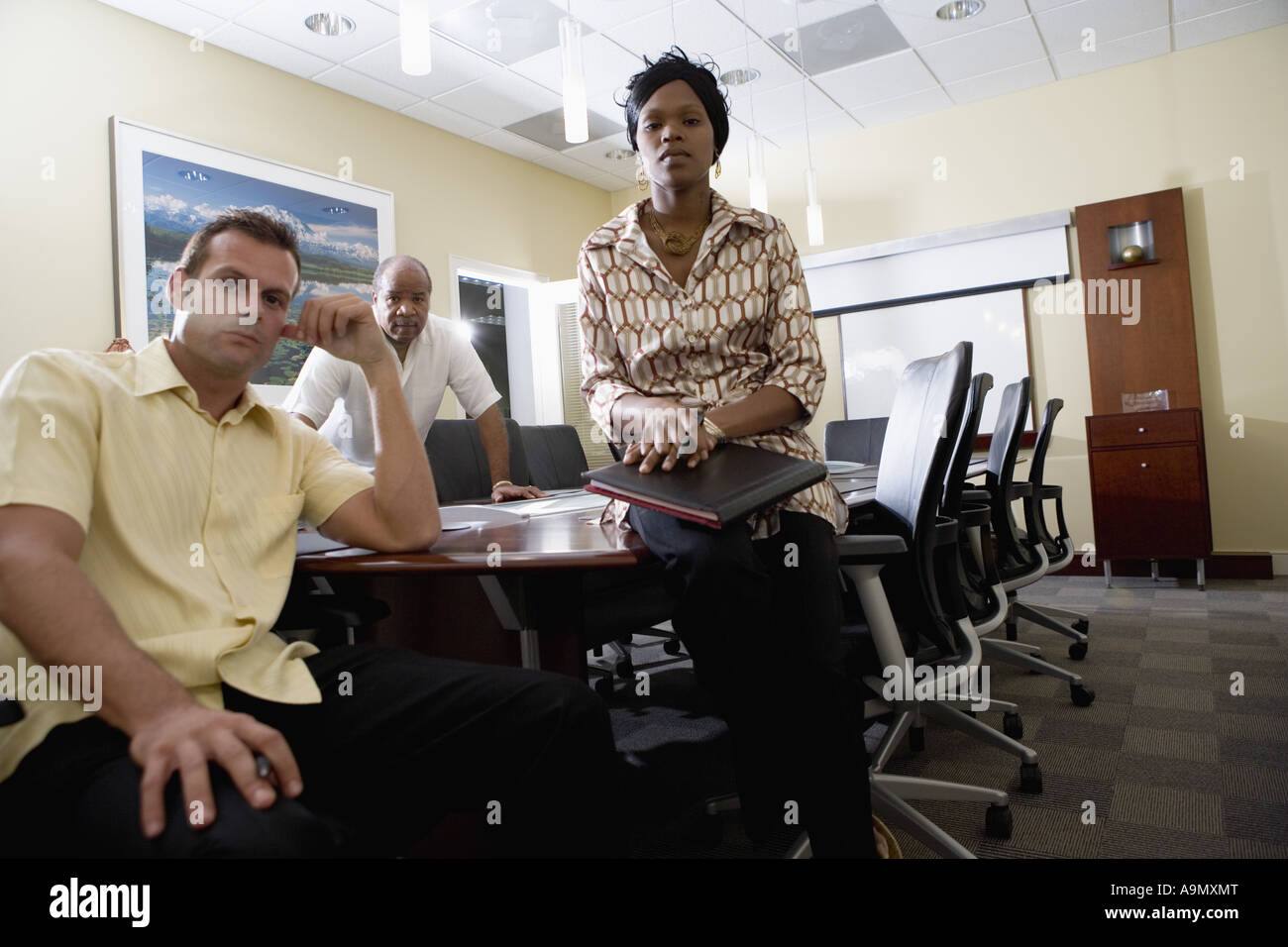 Portrait of three business people in a conference room Stock Photo - Alamy